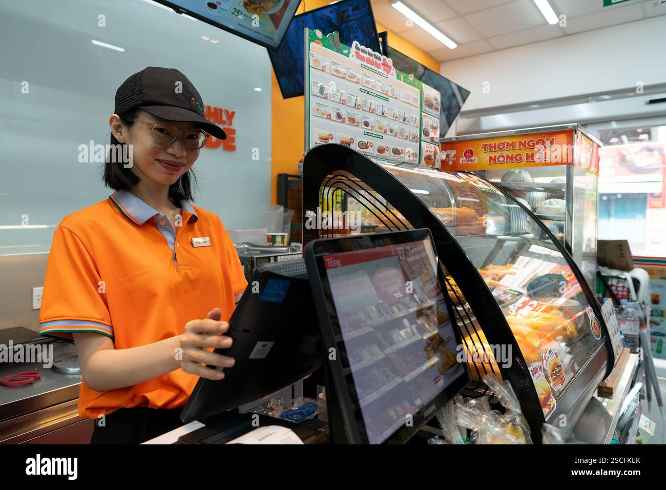 Ho Chi Minh, Vietnam - August 24, 2024: a cashier behind the counter at ...