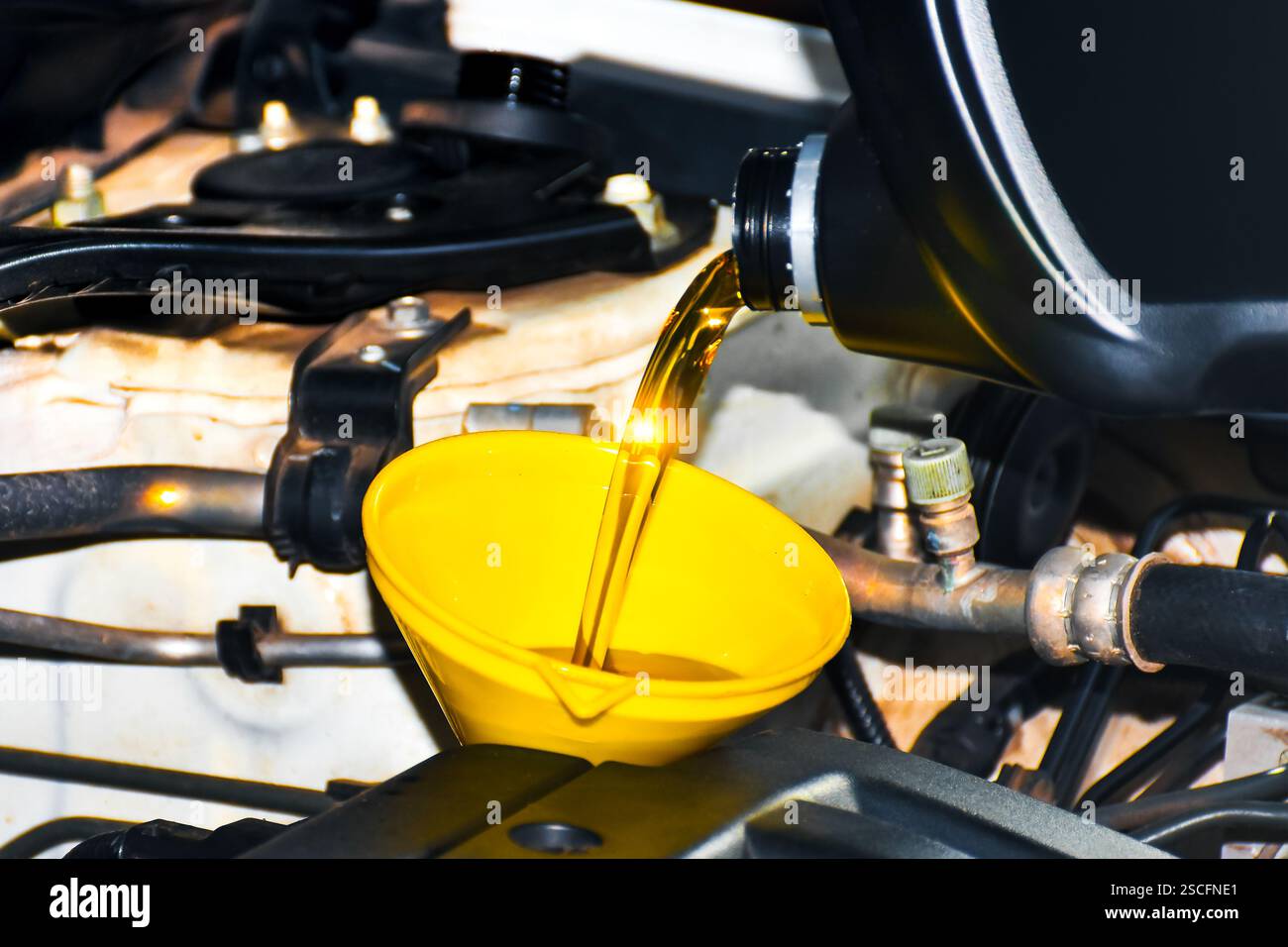 Engine oil pouring to yellow funnel , new engine oil change , car ...