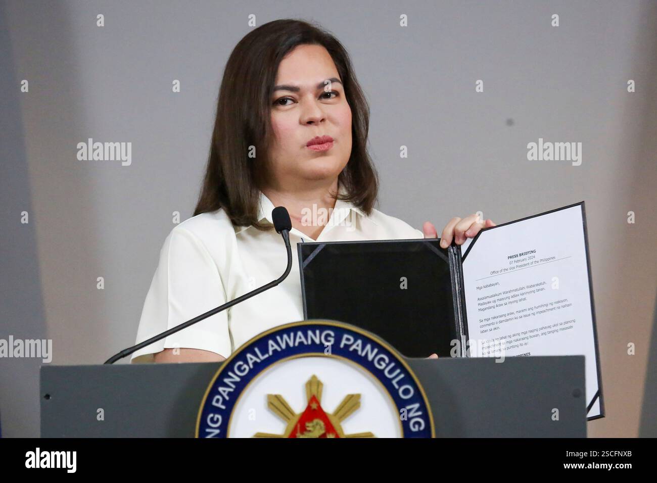 Philippine Vice President Sara Duterte holds a copy of her statement as ...