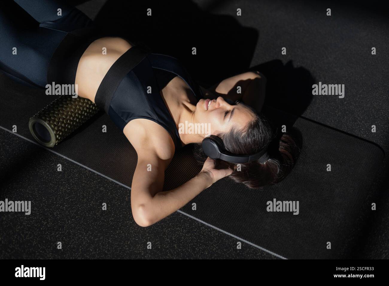 Strong fitness woman asian training her back, giving herself a massage ...