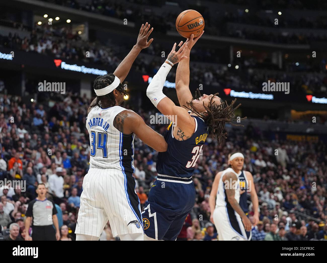 Denver Nuggets forward Aaron Gordon, front right, drives to the basket ...