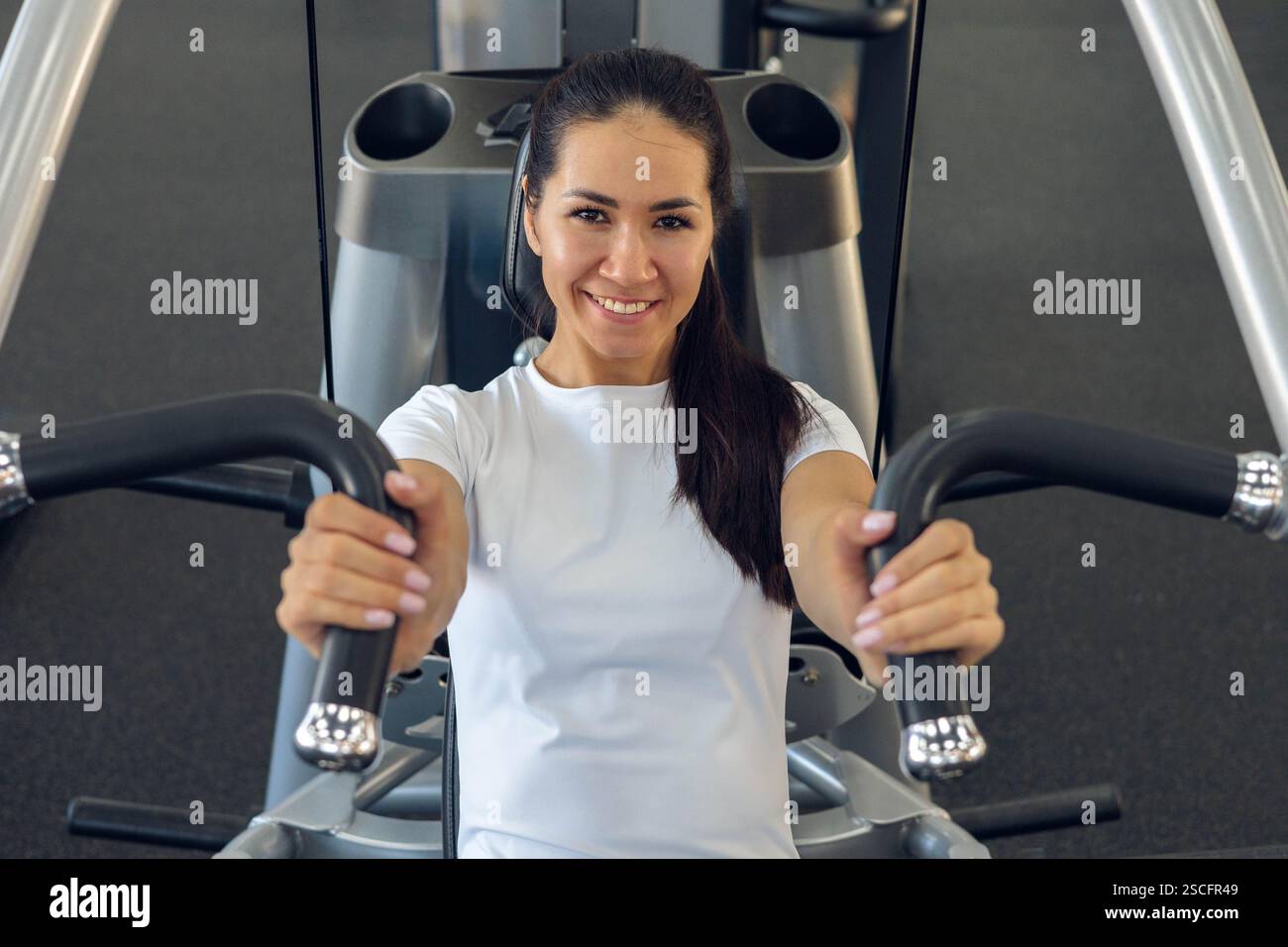 Portrait smiling Asian sport woman exercising on a strength training ...
