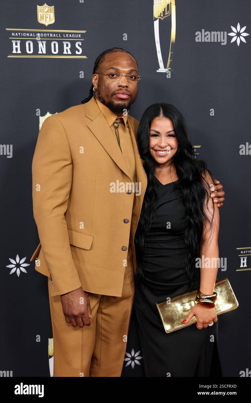 Derrick Henry, of the Baltimore Ravens, and guest, on the red carpet ...