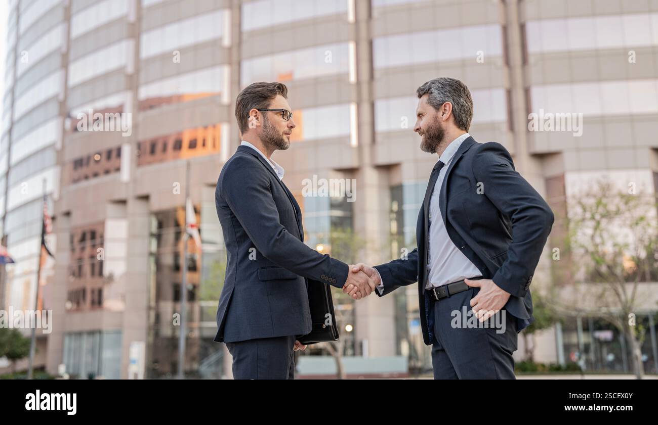 Celebrate business partnership. Two businessmen partner celebrating ...