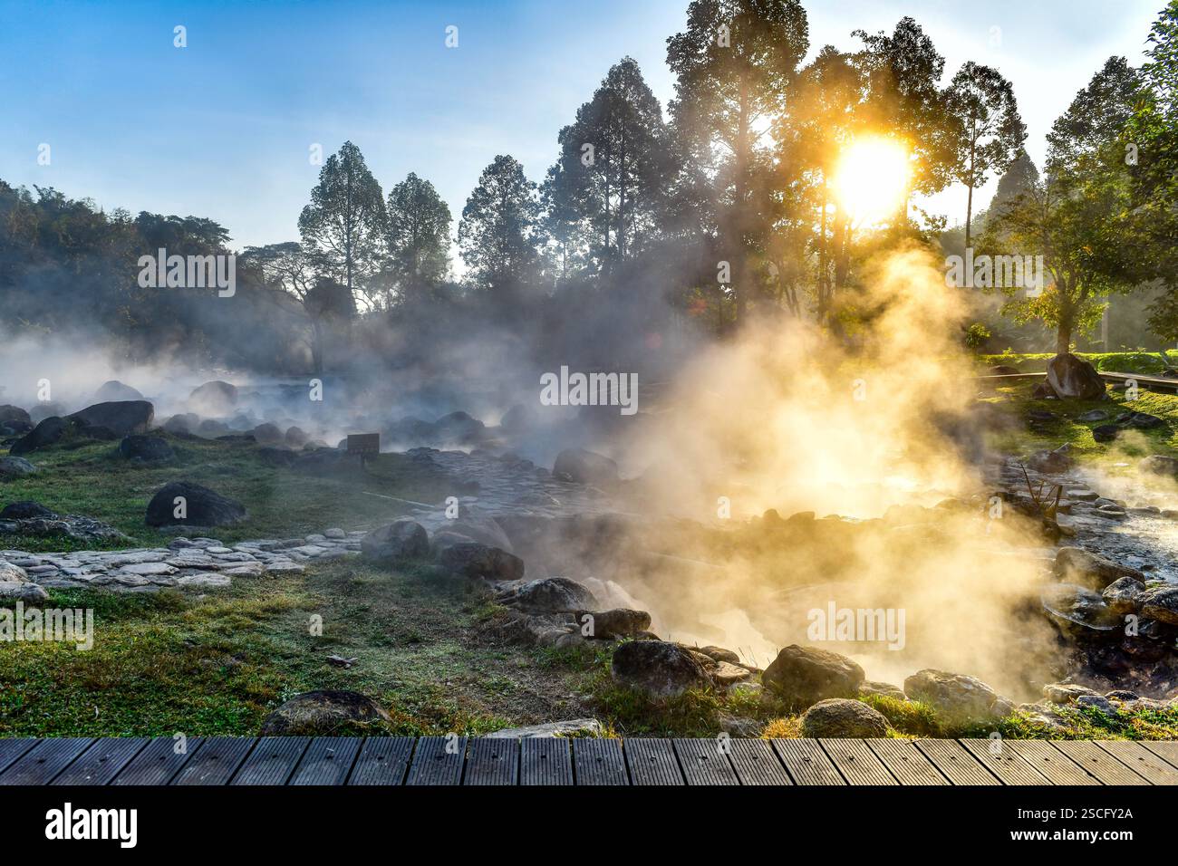 Natural hot spring with misty and morning sunrisewarm sunlight at Chae Son National Park ...