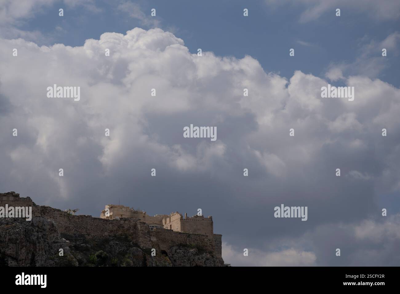 Acropolis under dramatic clouds from down in the city of Athens, Greece Stock Photo - Alamy