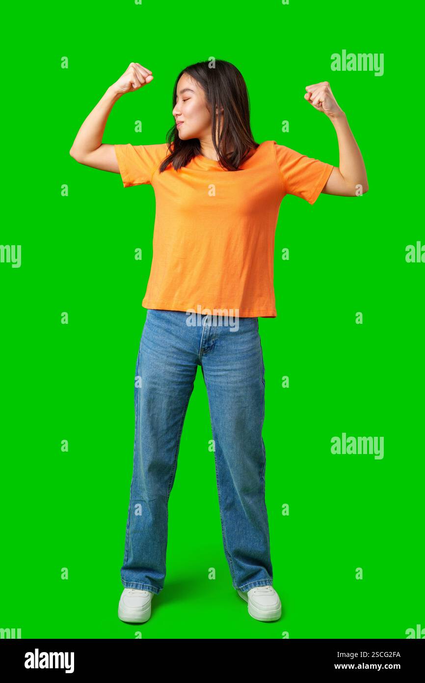 Woman flexes confidently in green hi-res stock photography and images ...