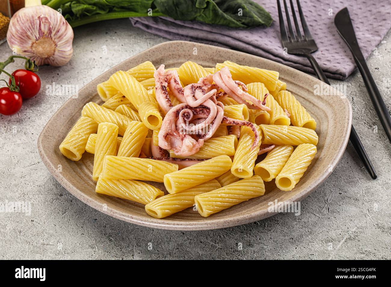 Italian cuisine - pasta tortiglioni with squid tentacles Stock Photo ...