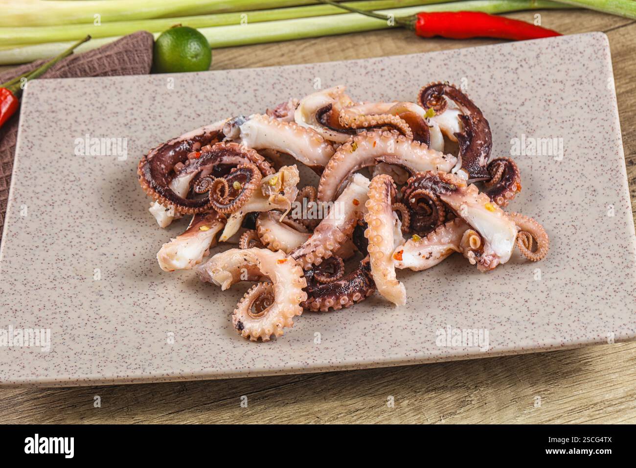 Grilled octopus red tentacle sliced appetizer Stock Photo - Alamy
