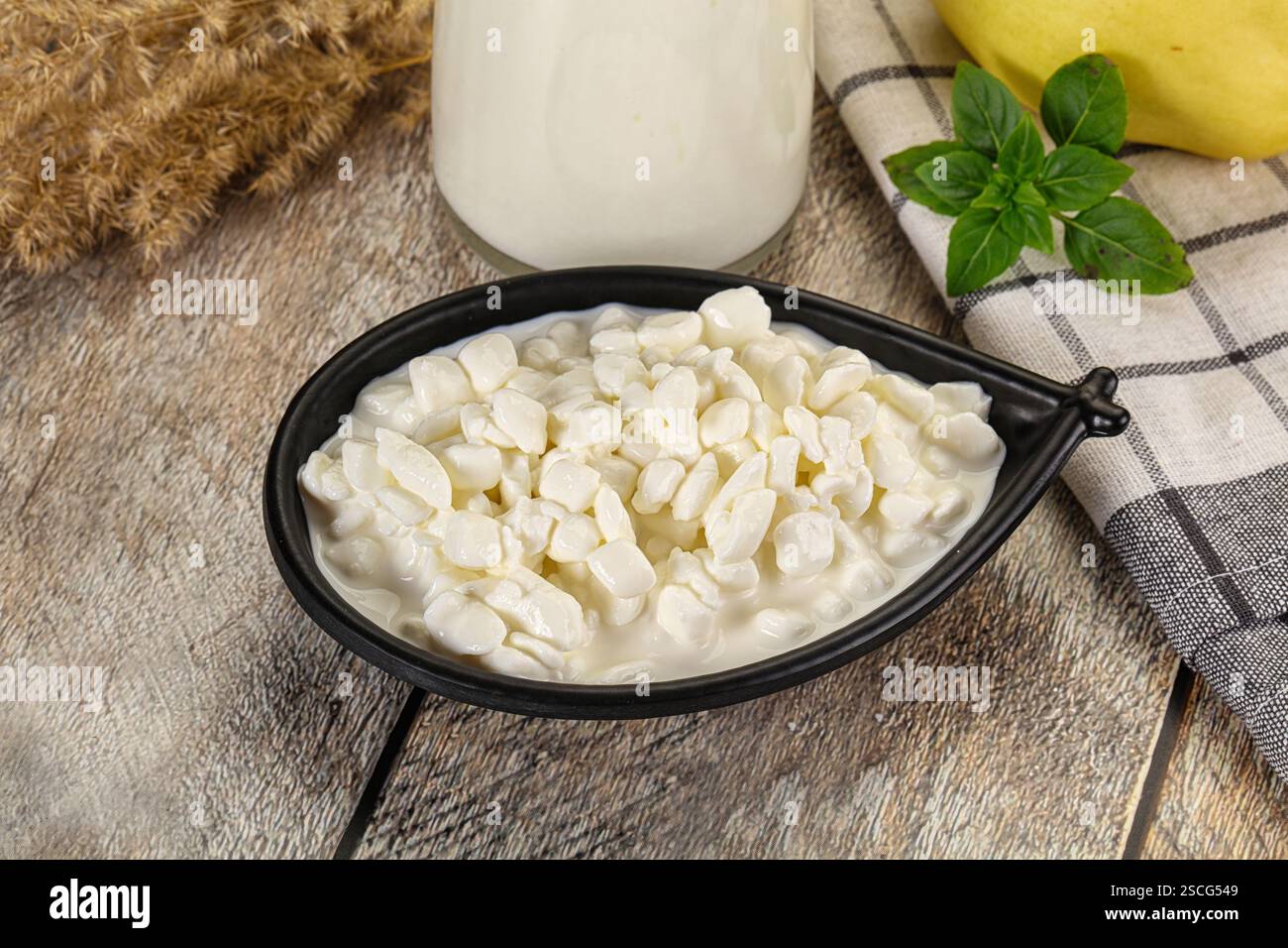 Grain cottage cheese with sour in the bowl Stock Photo - Alamy