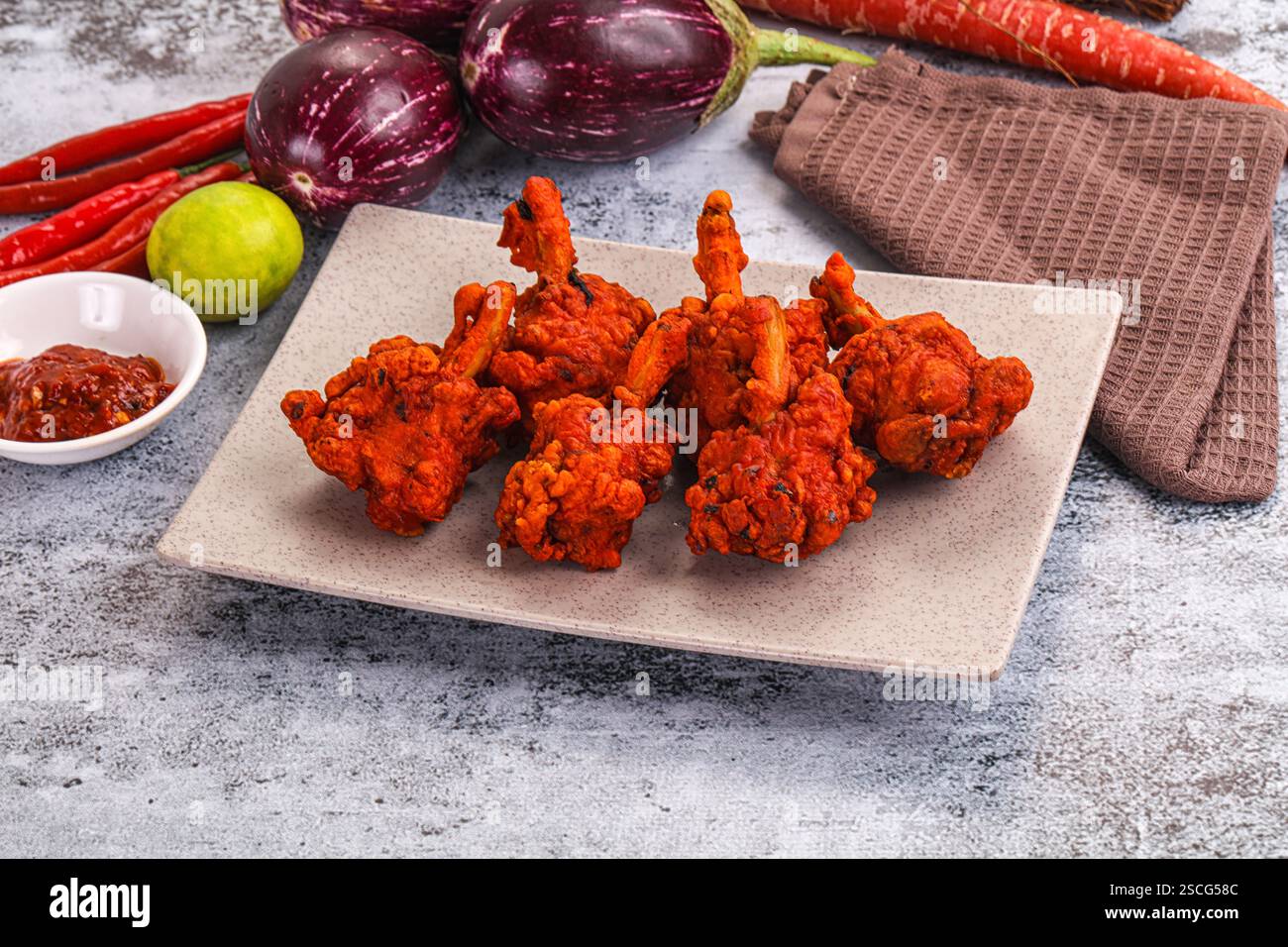 Indian cuisine - spicy red Chicken lollipop Stock Photo - Alamy