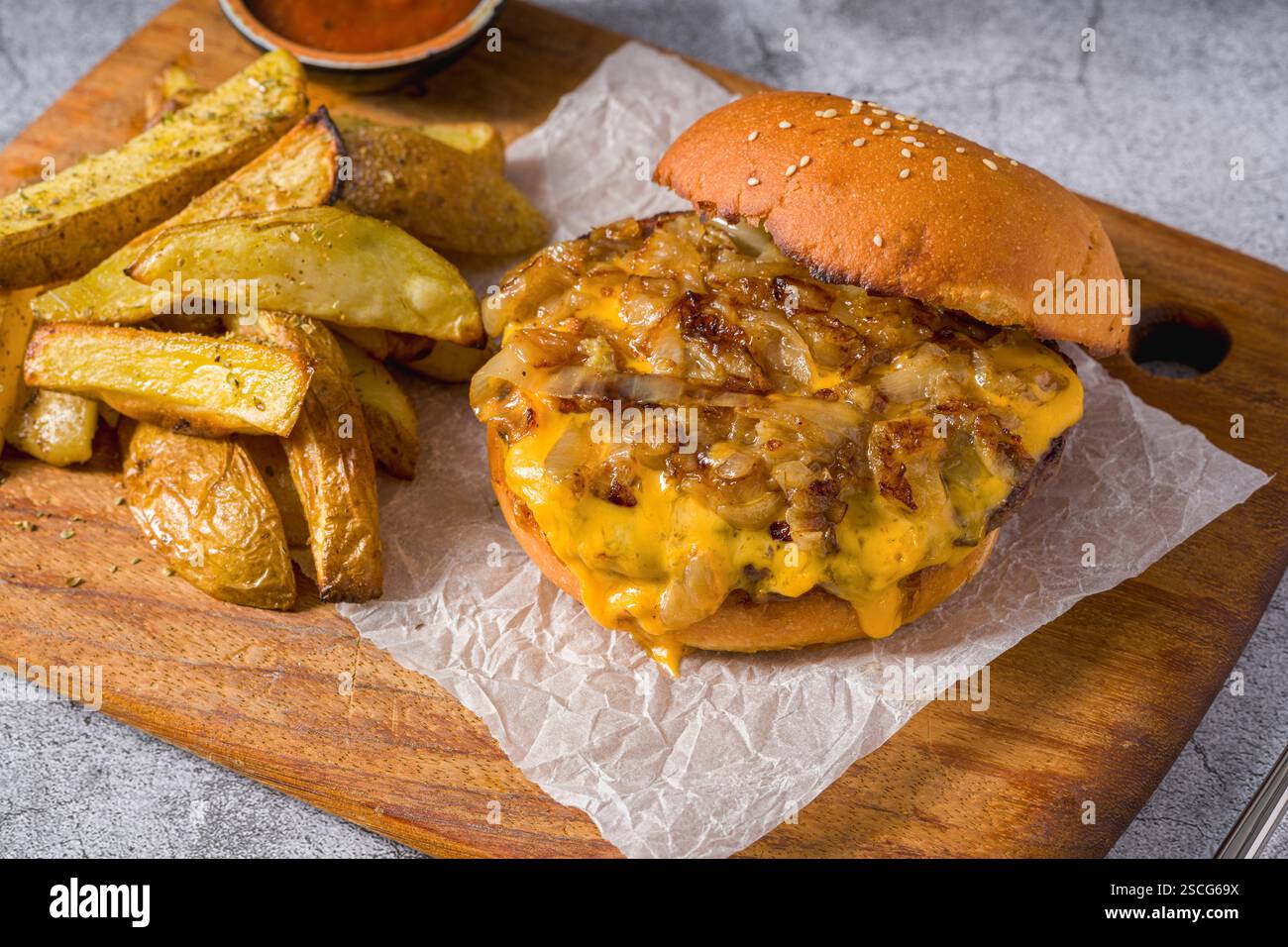 Smash burger with cheddar cheese and caramelized onions, served with ...