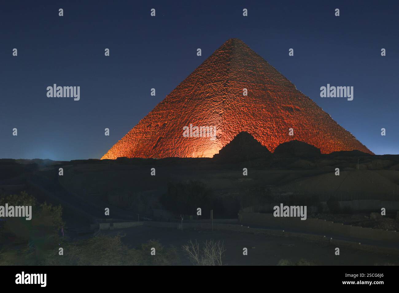 Colorfully illuminated Cheops Pyramid at night in the Giza Pyramid ...