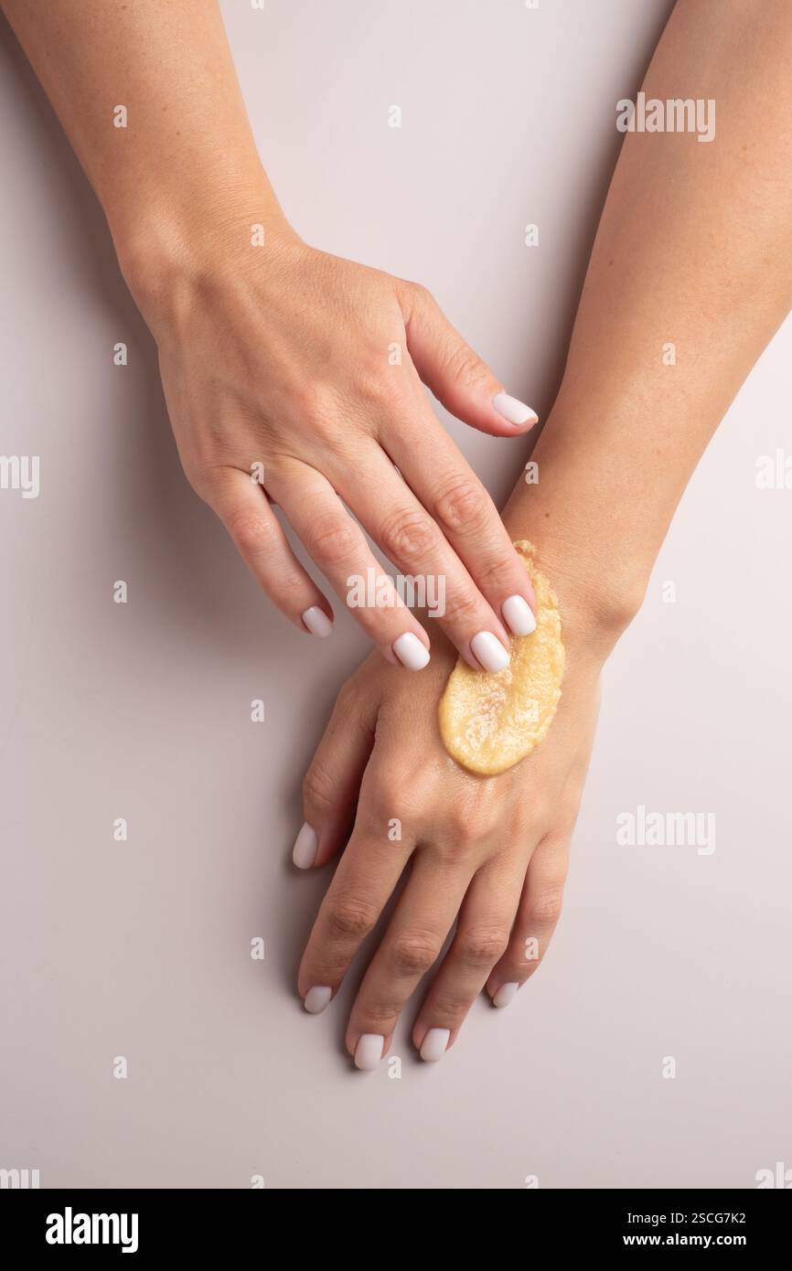 An orange smudge of scrub on a hand Stock Photo - Alamy