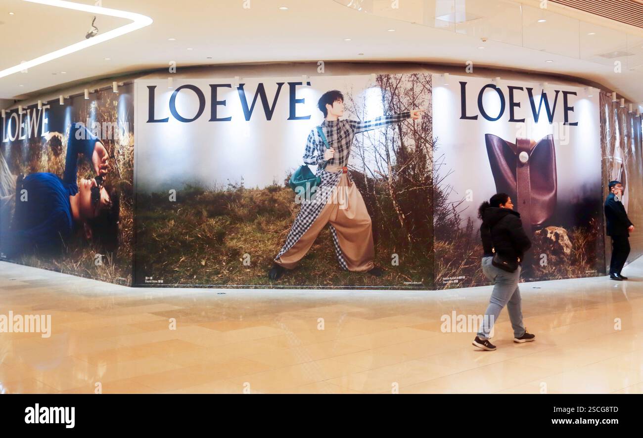 Pedestrians pass a huge poster featuring Chinese star Wang Yibo, who is ...