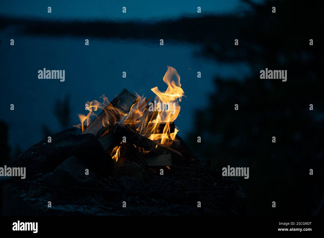 Orange flames from fire outside on a hike Stock Photo - Alamy