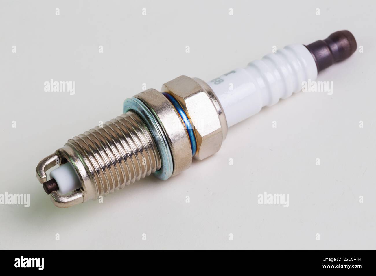 The sparking plug on a white background Stock Photo - Alamy