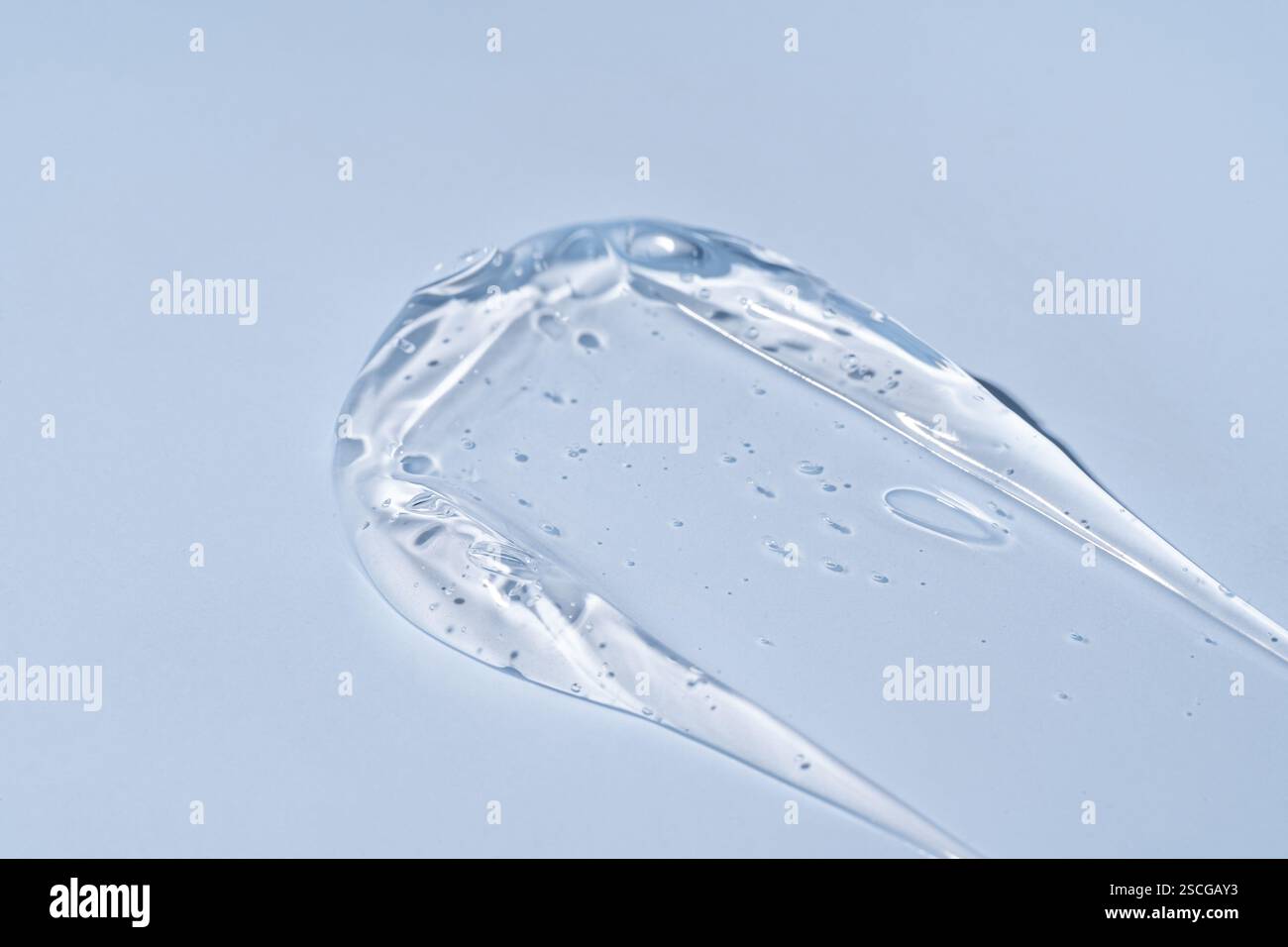 Skin care gel, face serum, swatch smear on blue background. Transparent ...