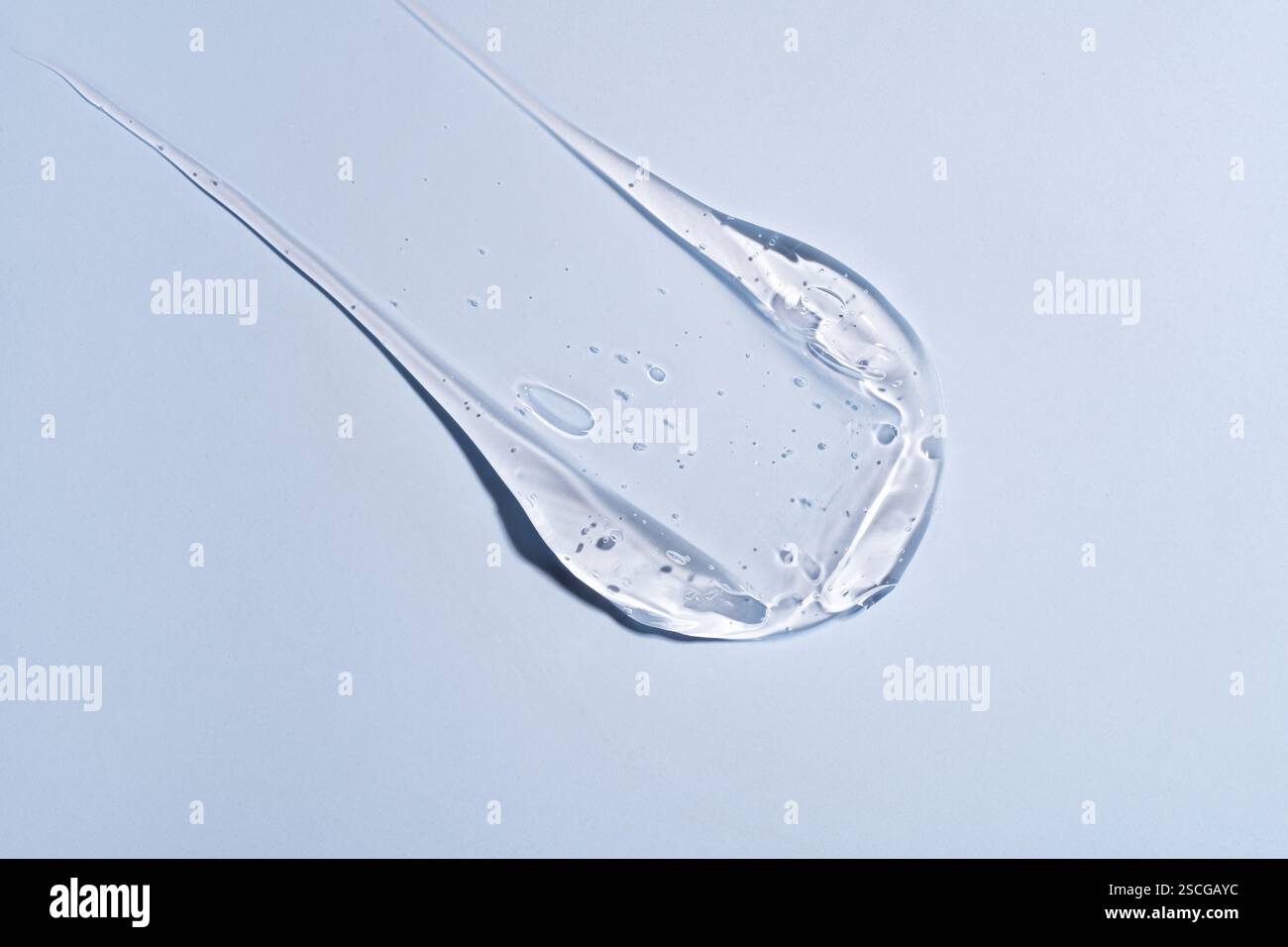 Skin care gel, face serum, swatch smear on blue background. Transparent ...