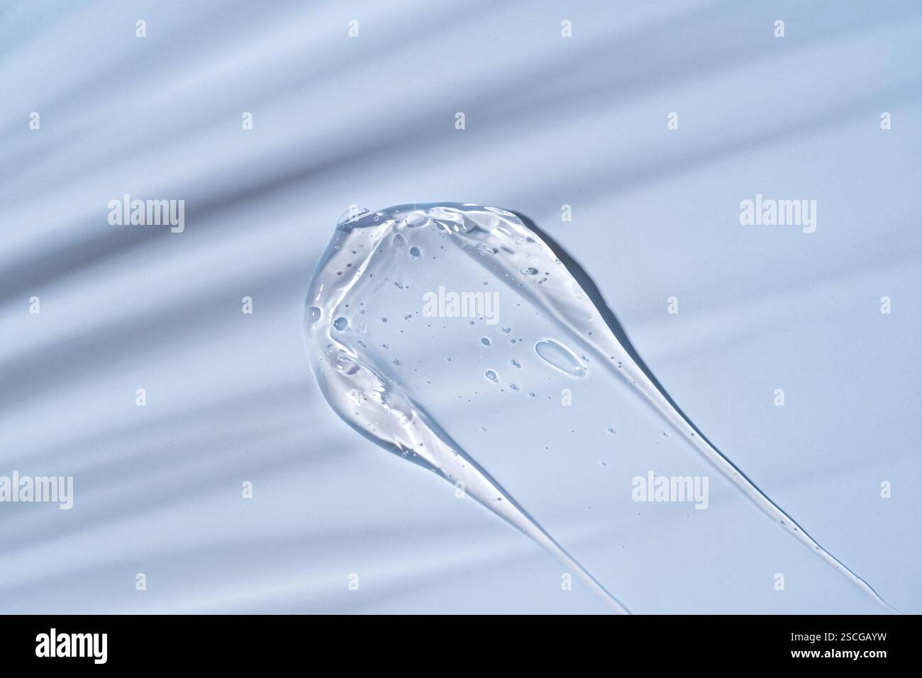 Skin care gel, face serum, swatch smear on blue background. Transparent ...