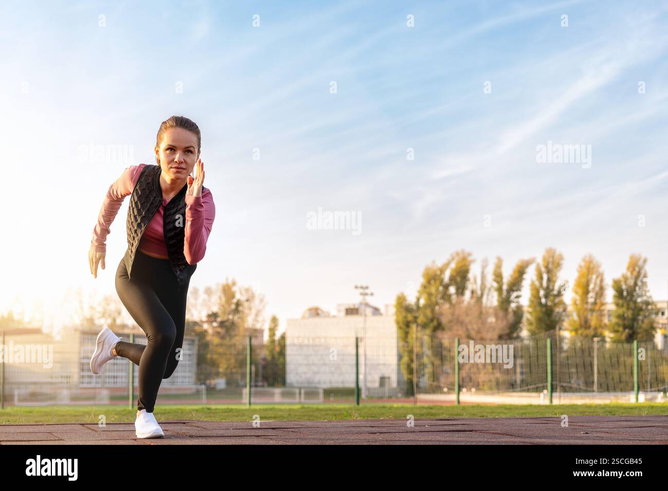 Female athlete performing cardio exercises outdoors Stock Photo - Alamy