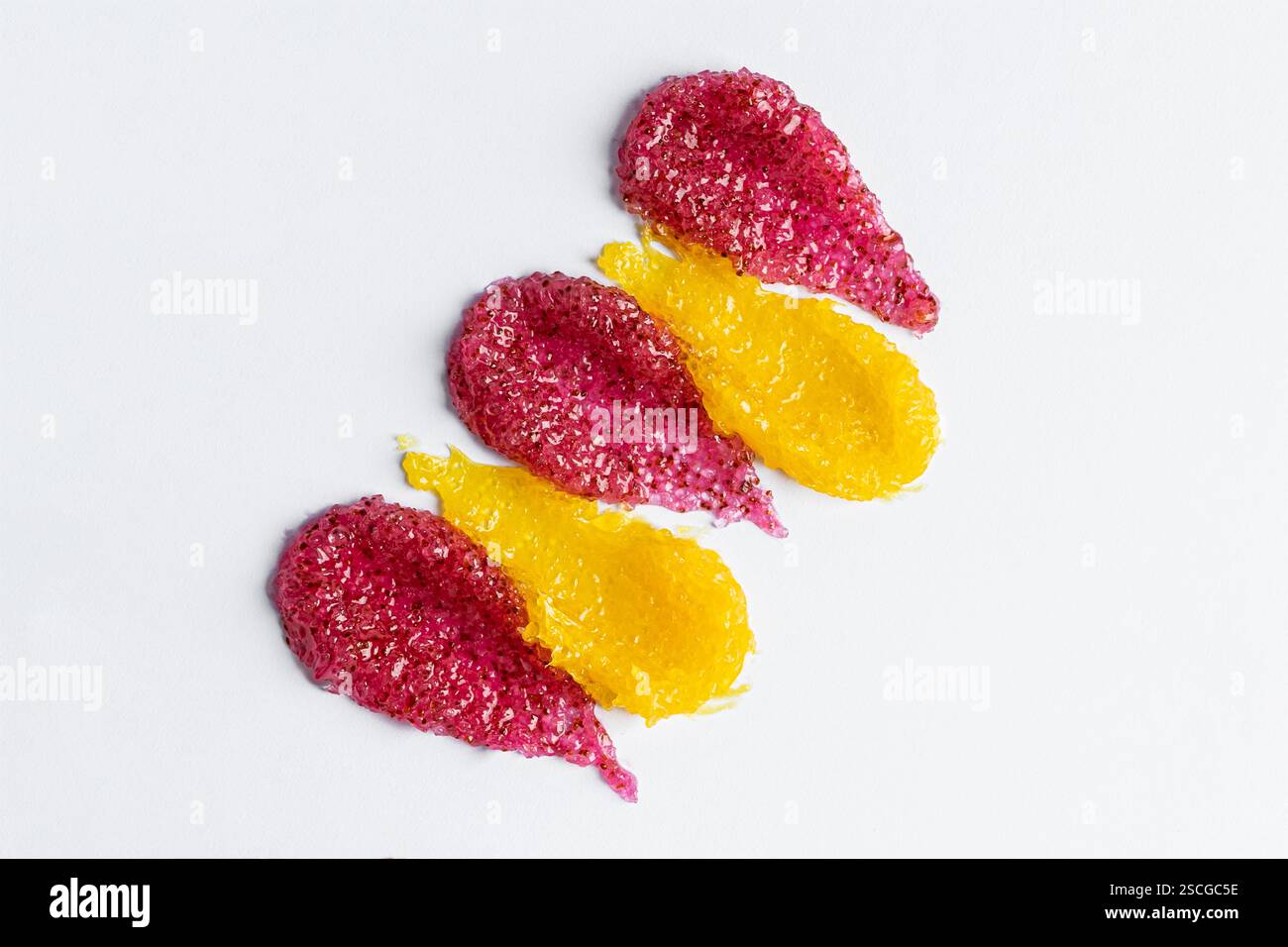 A row of colorful swatches of the berry and mango body scrub. Skincare ...