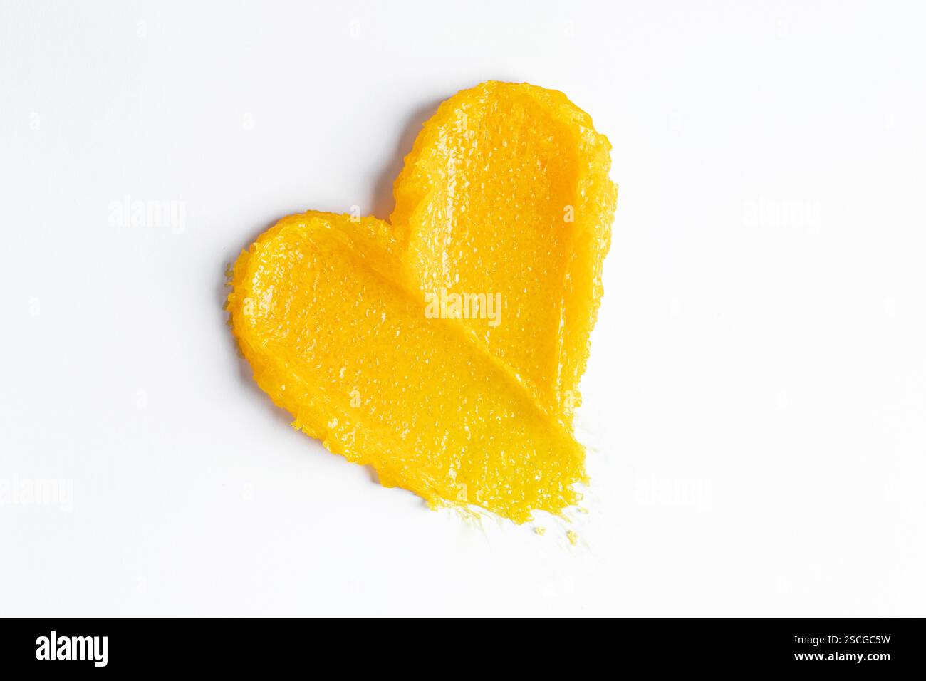 Bright yellow swatches of the mango body scrub. Skincare cosmetic cream ...