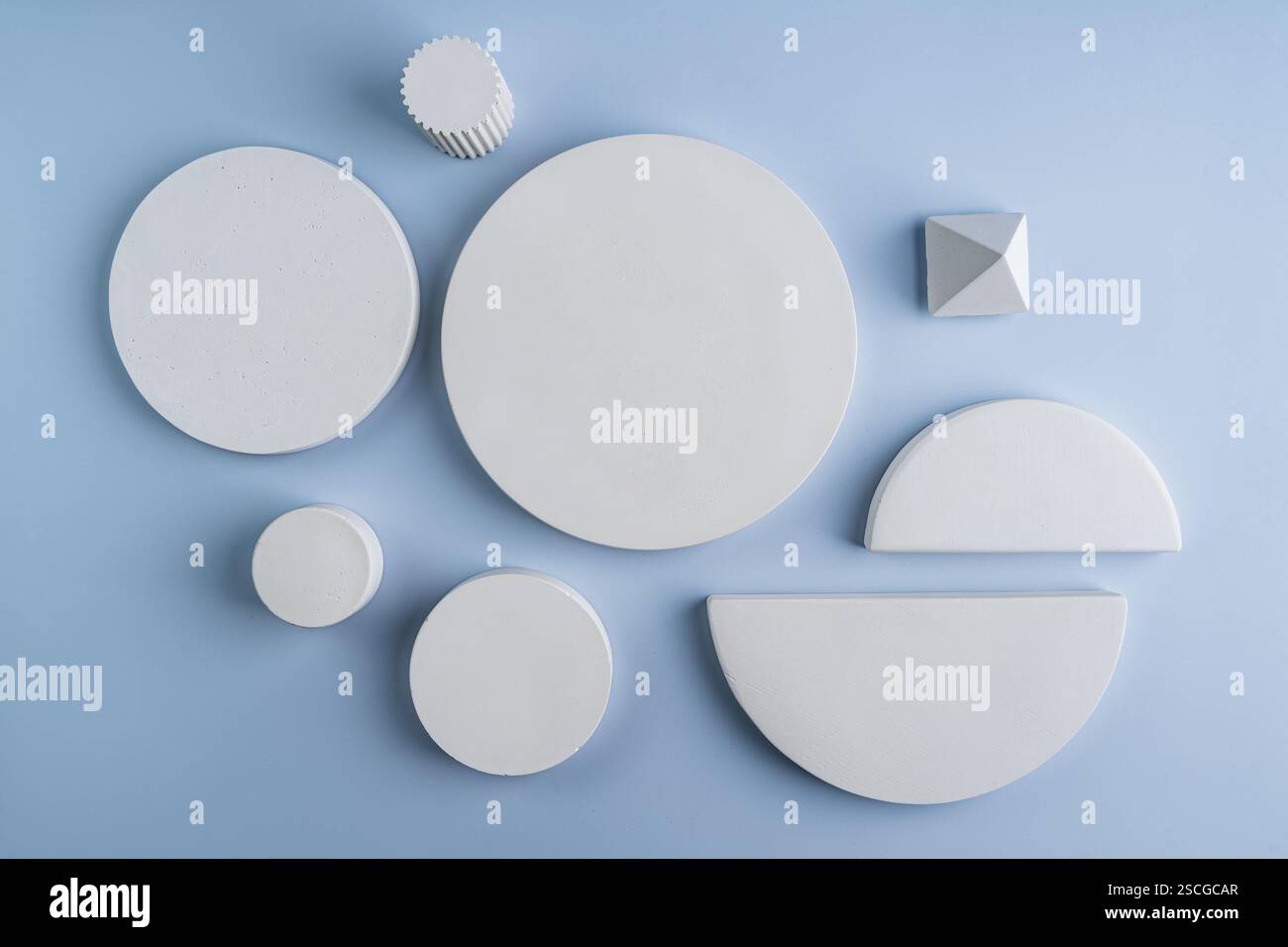 White geometric podiums made of concrete circles of different forms and ...