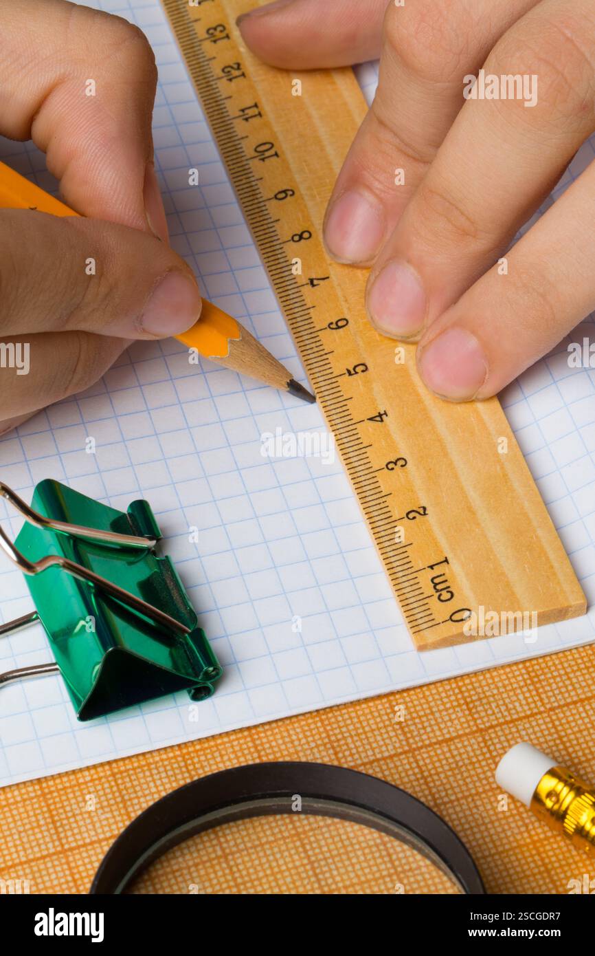draftsman draws on a ruler on the graph paper Stock Photo - Alamy