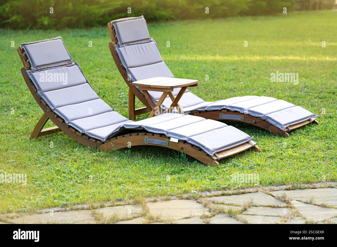 Two sun beds standing in the garden for relaxation Stock Photo - Alamy