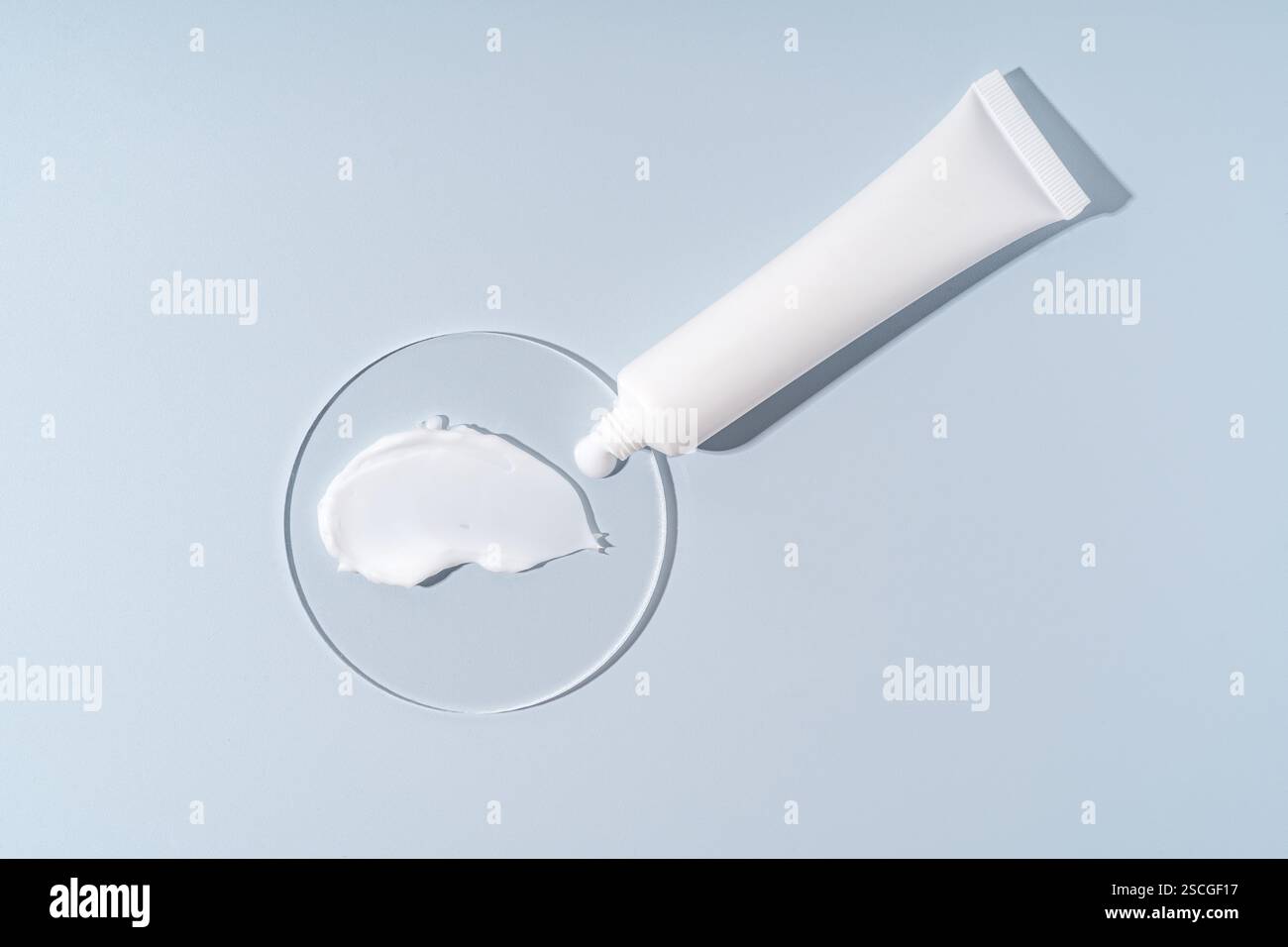 Mockup white tubes of cream for face lying on texture of smear, product ...