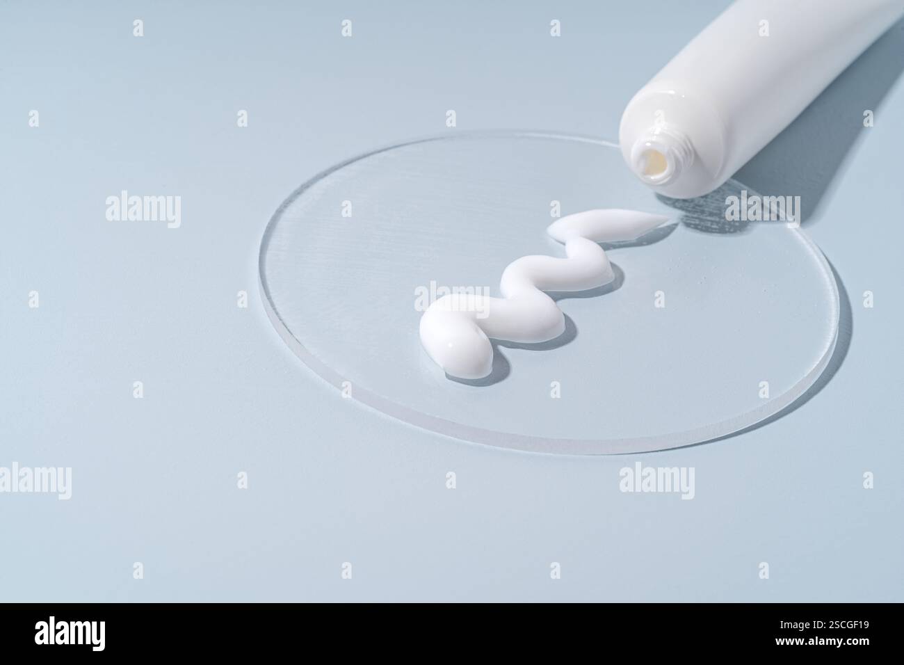 Mockup white tubes of cream for face lying on texture of scrub smear ...