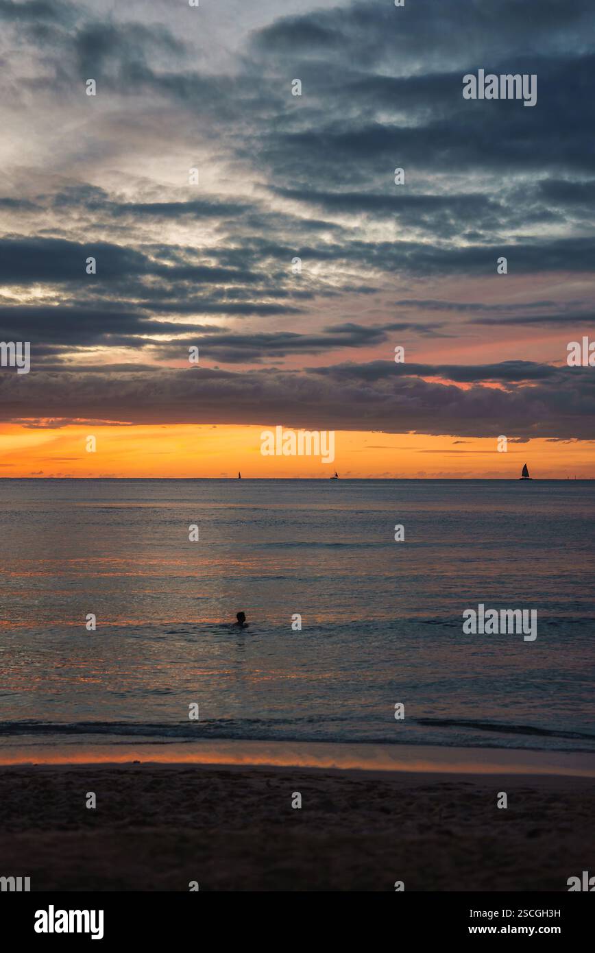 Serene Sunset Over Ocean with Sailboats and Swimmer at Waikiki Beach ...