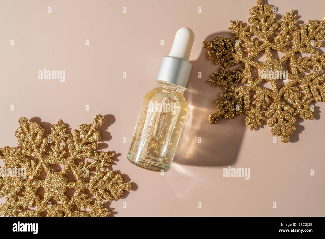 A natural transparent hyaluronic face serum or essential oil lying on a ...