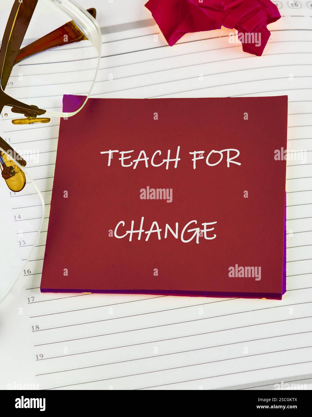 A message about transformative education is highlighted on a notepad, symbolizing efforts to ...