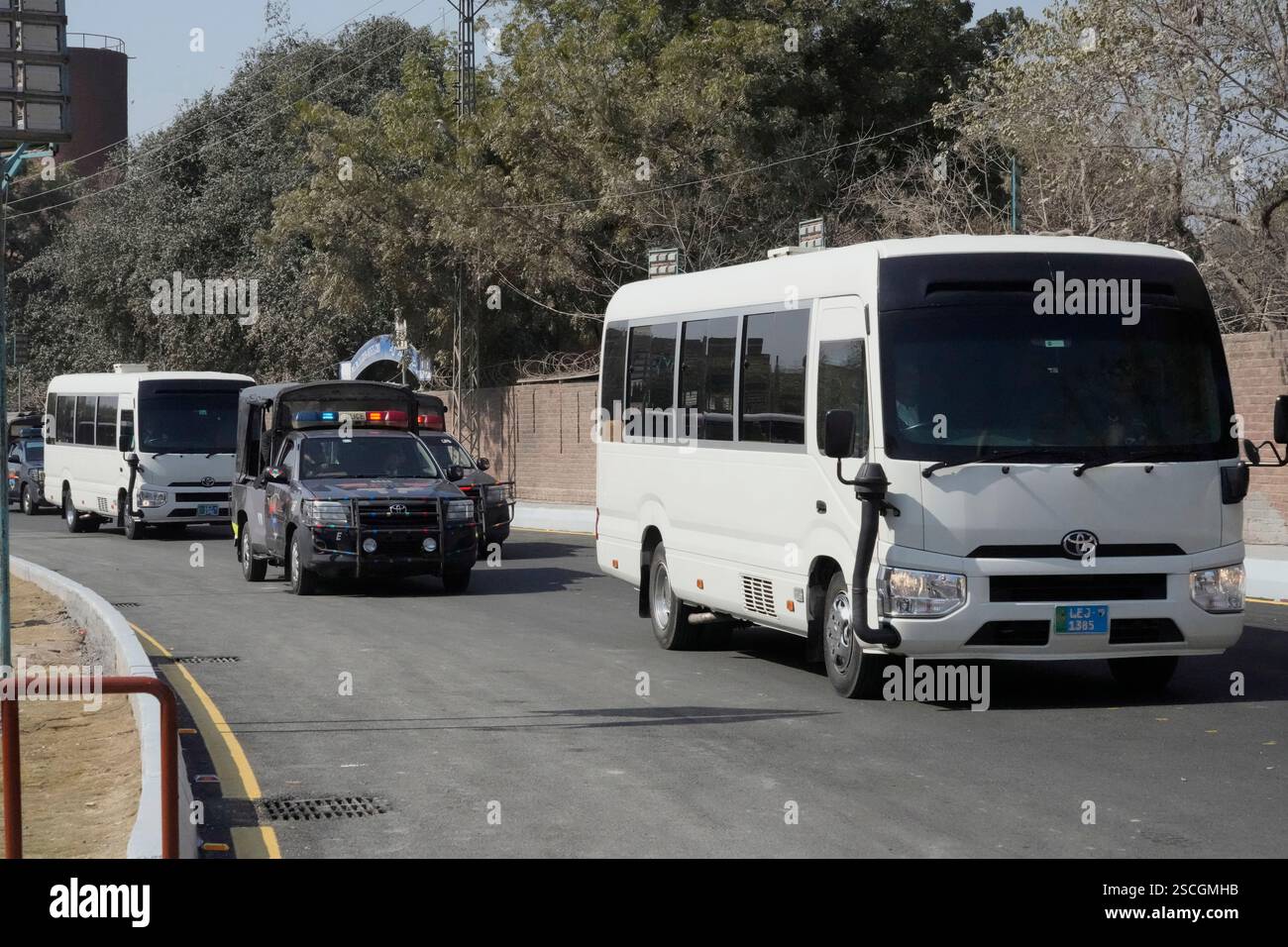Police vehicle escorts mini-buses carrying New Zealand cricket team ...