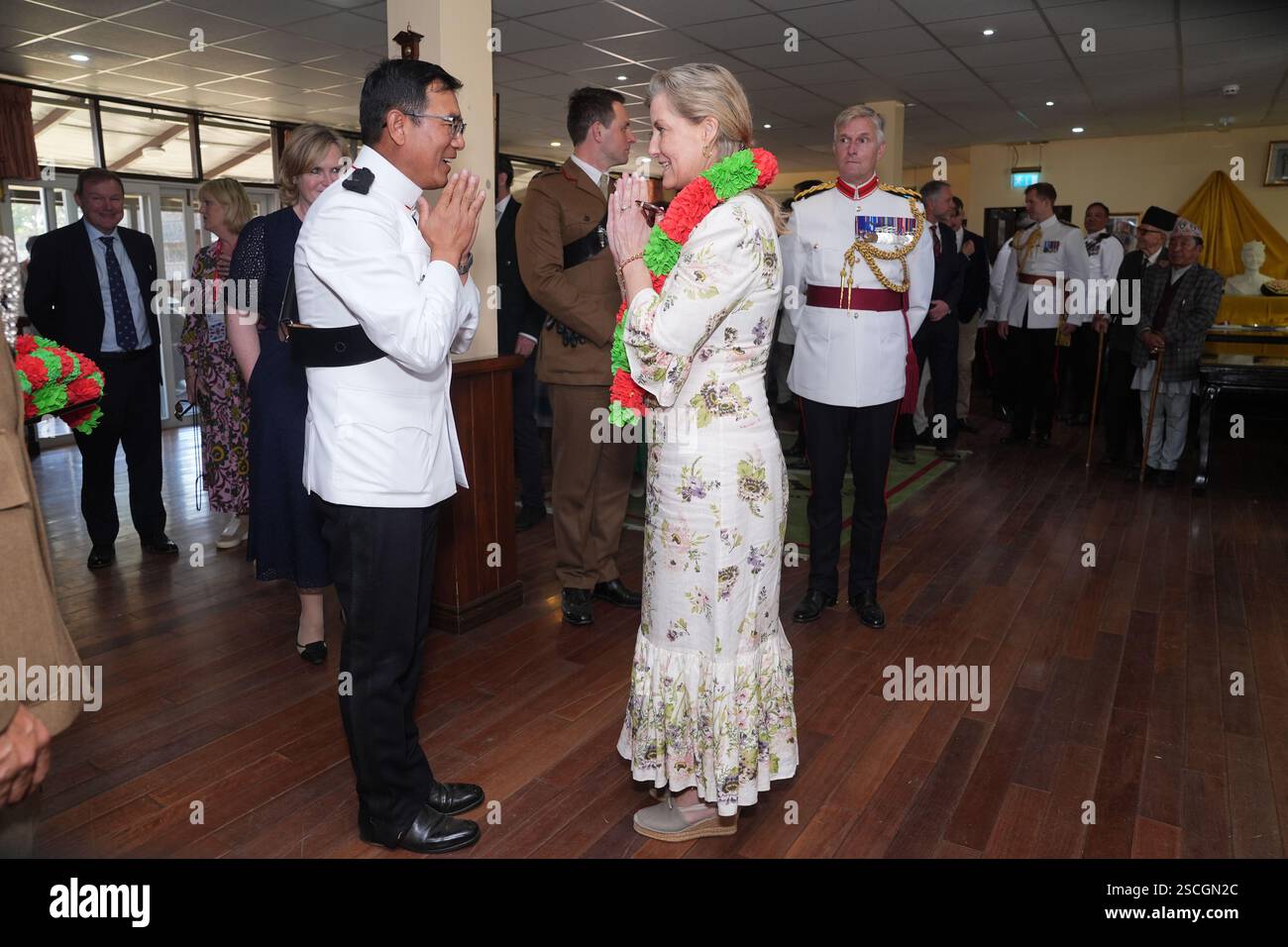 Gurkha Major Maj Gyanbahadur Dhenga (left) presents a Gurkha garland to ...