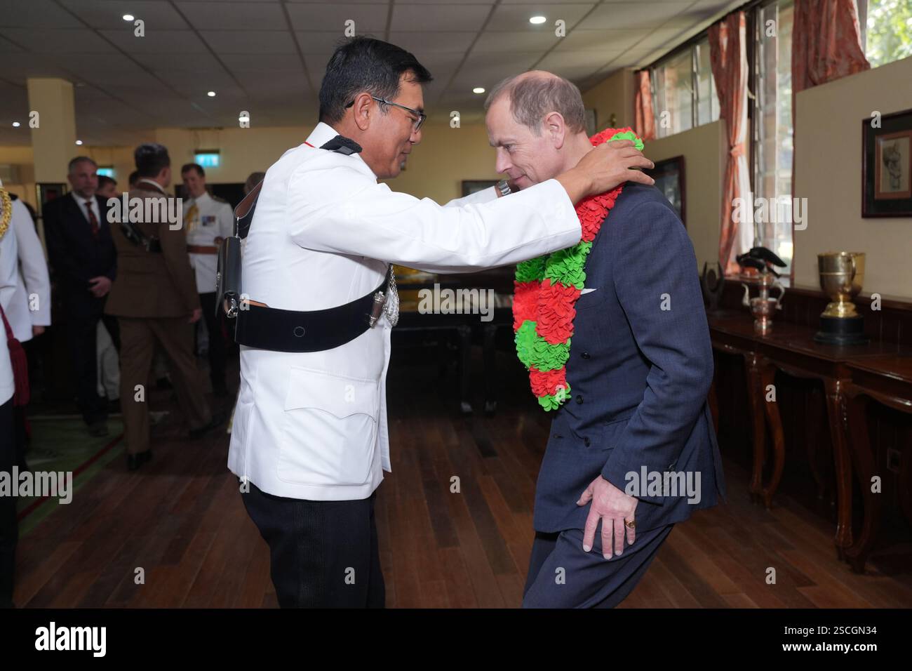 Gurkha Major Maj Gyanbahadur Dhenga (left) presents a Gurkha garland to ...