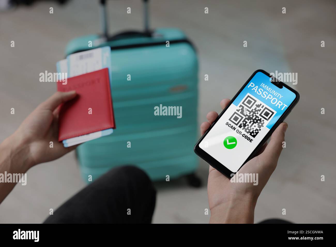 Tourist with passport, flight tickets and mobile phone indoors, above ...