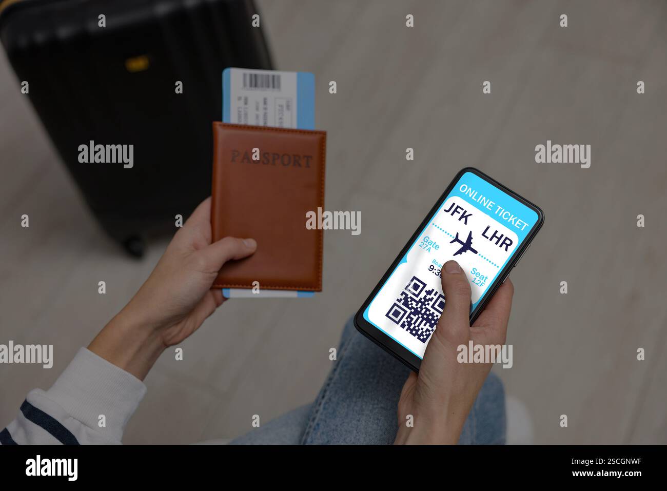 Tourist with passport, flight ticket and mobile phone indoors, above ...