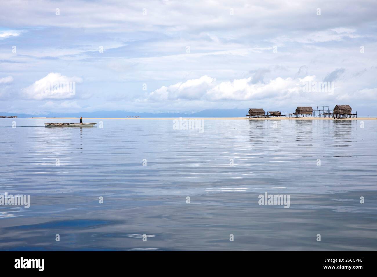 traditional wooden fishing boat and wooden houses on stilts of bajau ...