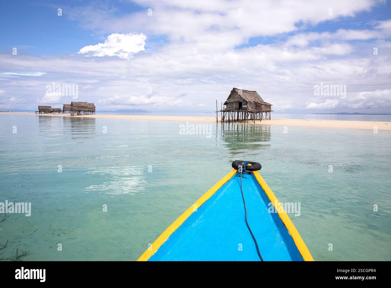 traditional wooden fishing boat and wooden houses on stilts of bajau ...