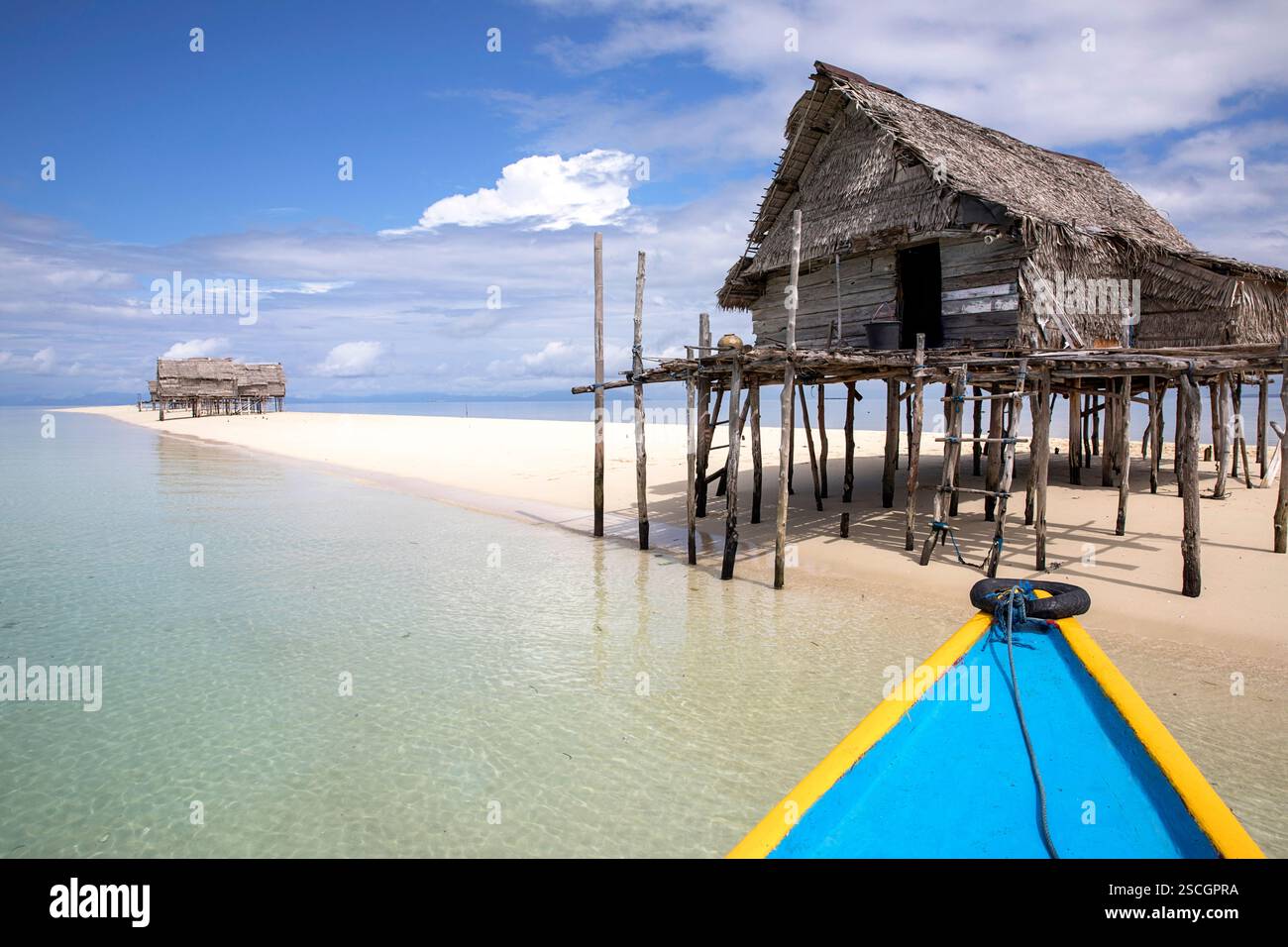 traditional wooden fishing boat and wooden houses on stilts of bajau ...