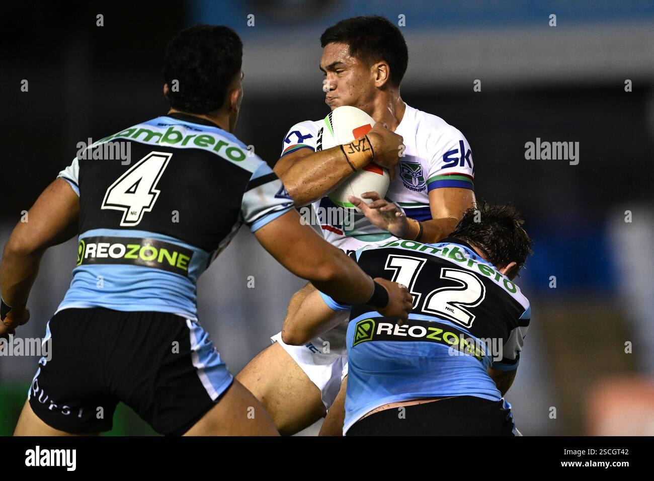 Taine Tuaupiki of the Warriors is tackled by Kayal Iro (left) and Billy ...