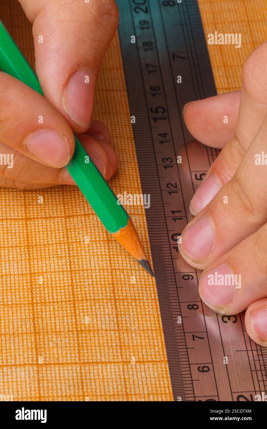 draftsman draws on a ruler on the graph paper Stock Photo - Alamy