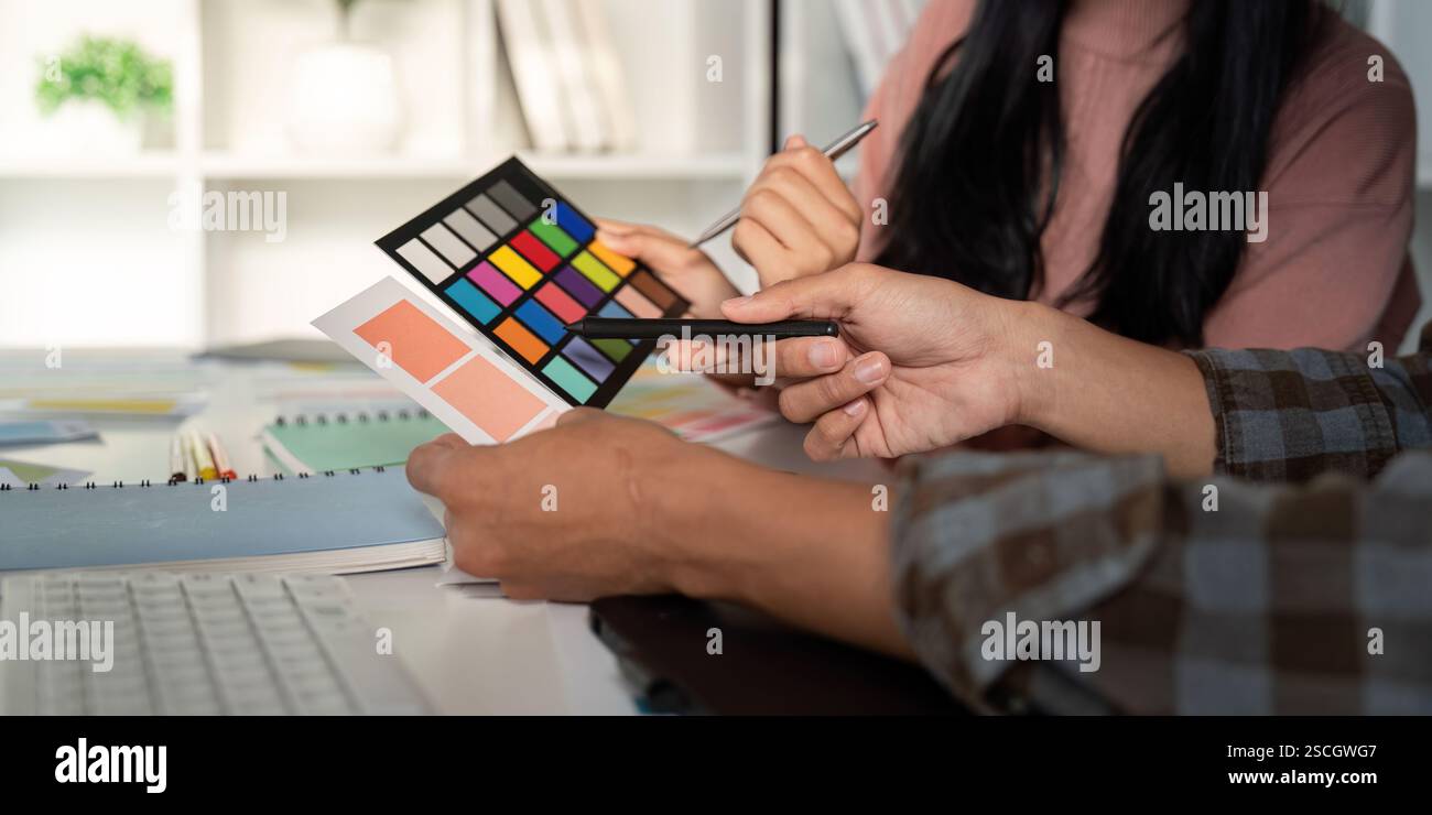 Diverse team evaluating color palettes for graphic design project Stock ...