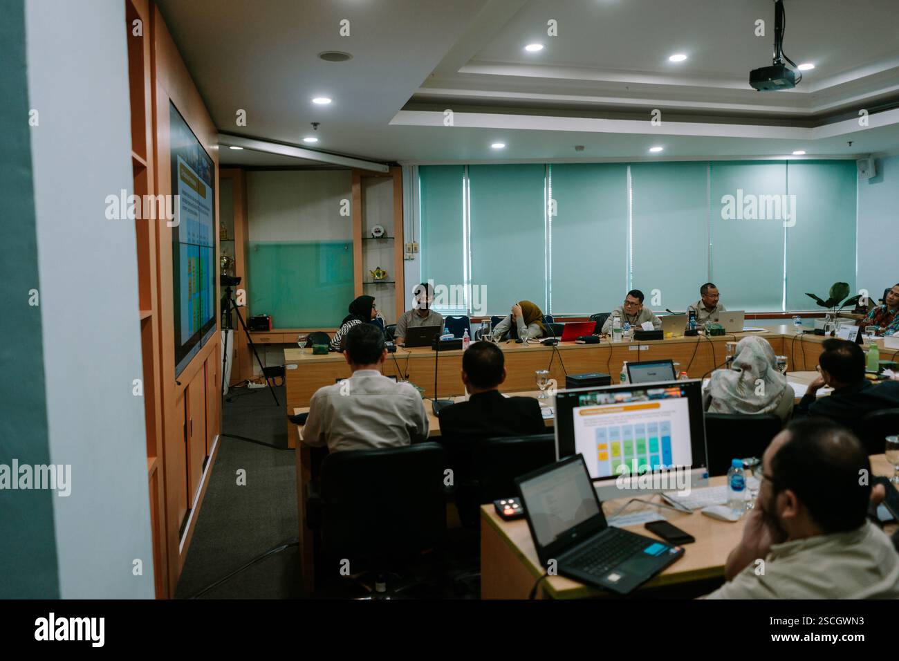 Jakarta, February 6, 2025. Group of people attending a meeting in a ...