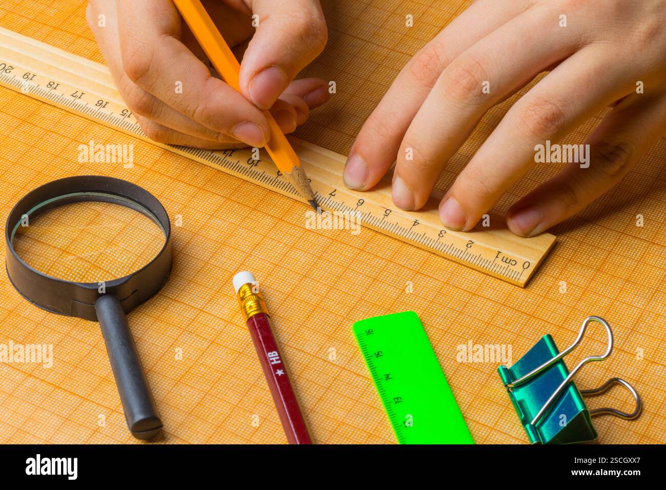 draftsman draws on a ruler on the graph paper Stock Photo - Alamy