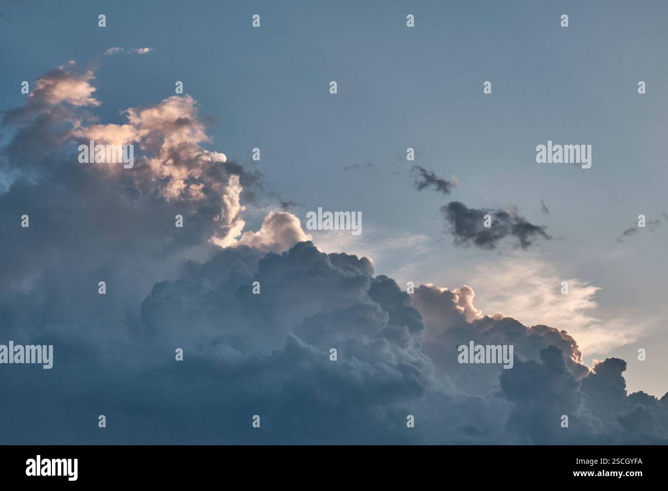 Stunning sky filled with towering cumulus clouds, illuminated by soft ...