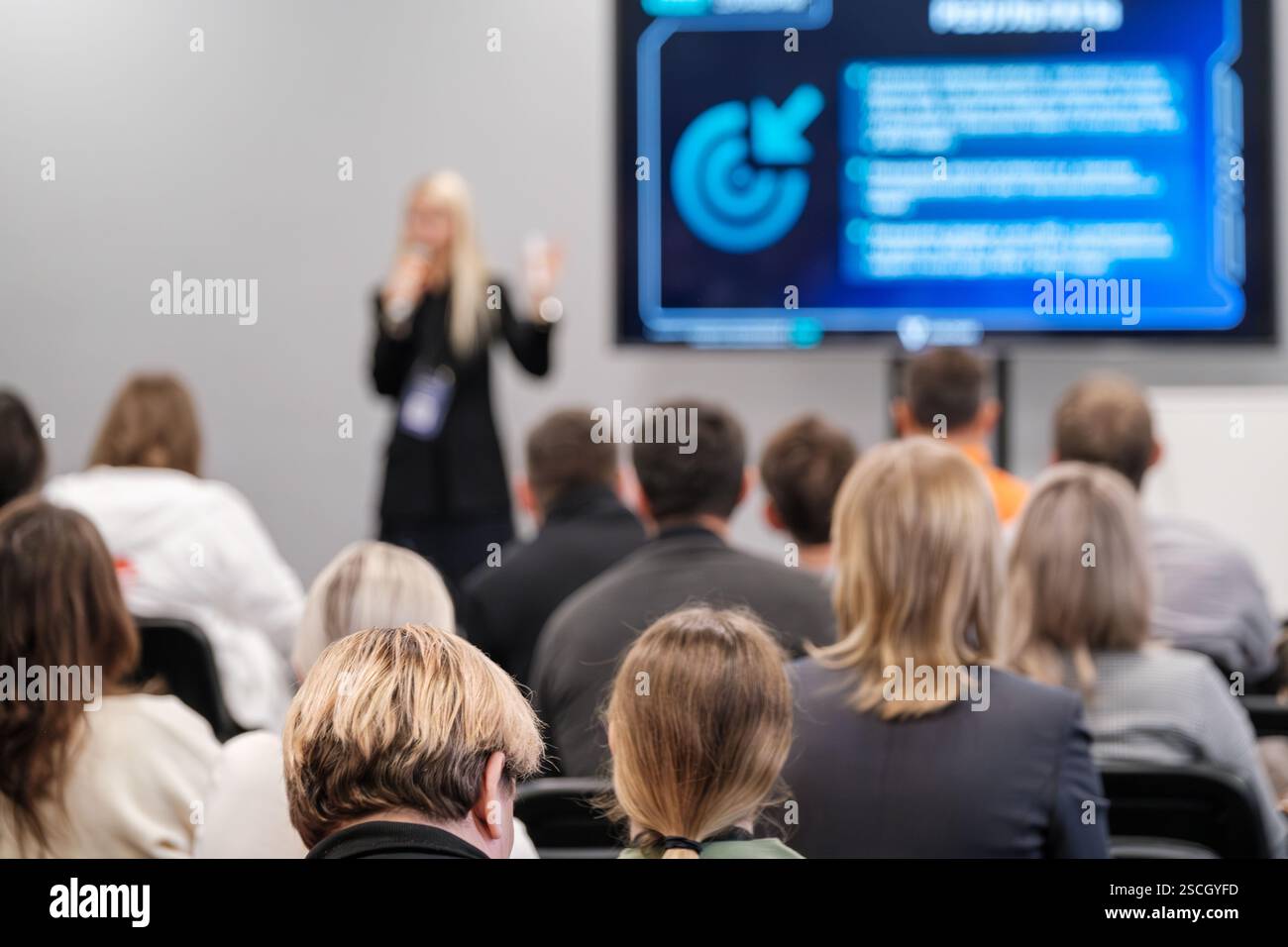 Audience engaged in business presentation led by speaker, focusing on ...